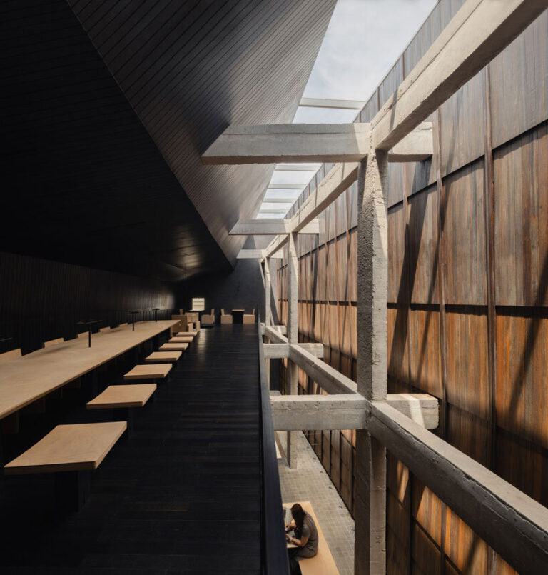 light and rain pour through internal courtyard within dessert shop in ...