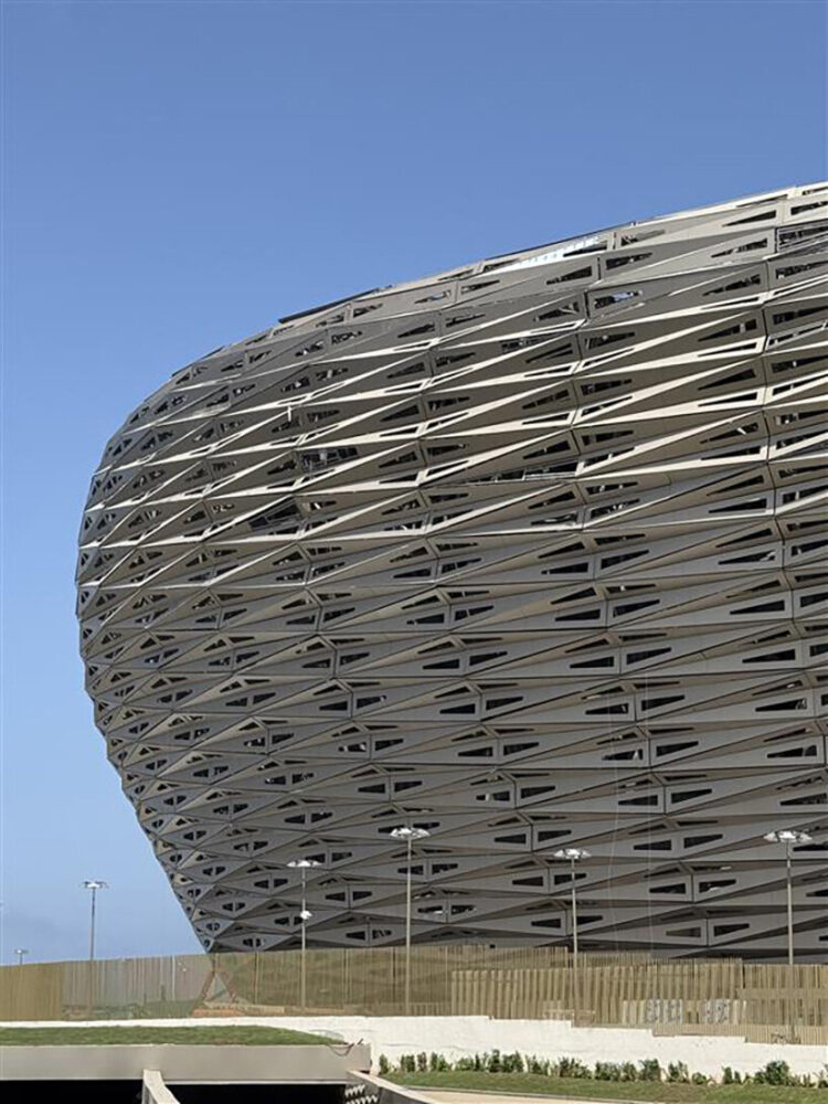 golden triangles compose the facade of populous' stadium in morocco