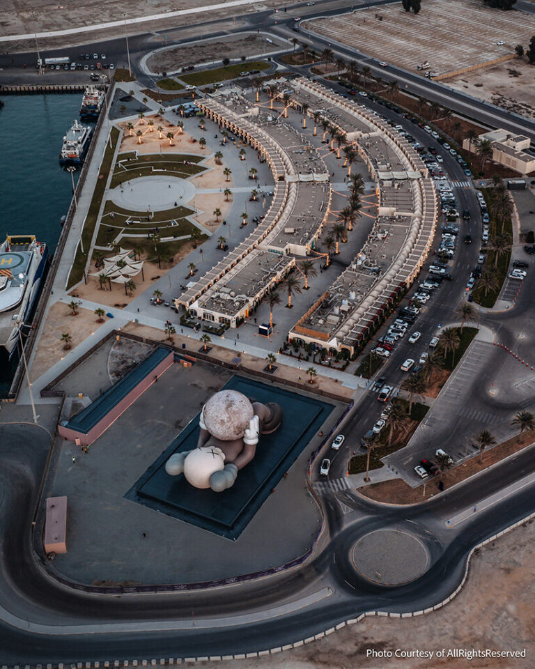 KAWS' companion lifts glowing moon along abu dhabi's waterfront