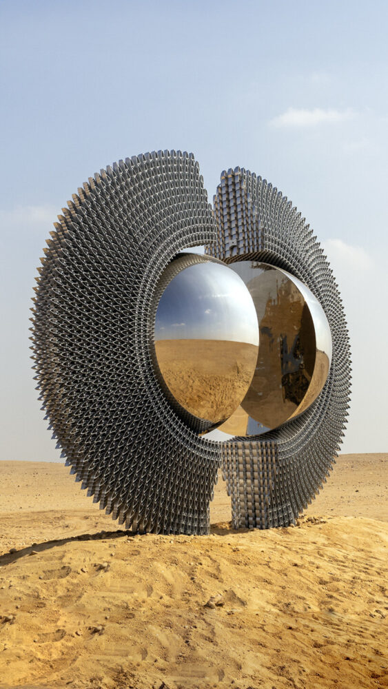 reflective ring sculpture by mert ege köse frames the giza pyramids